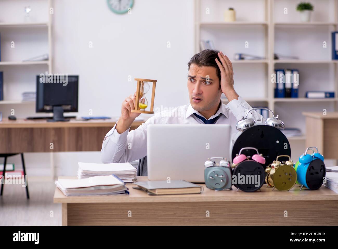 Young employee afraid of missing deadline at workplace Stock Photo - Alamy