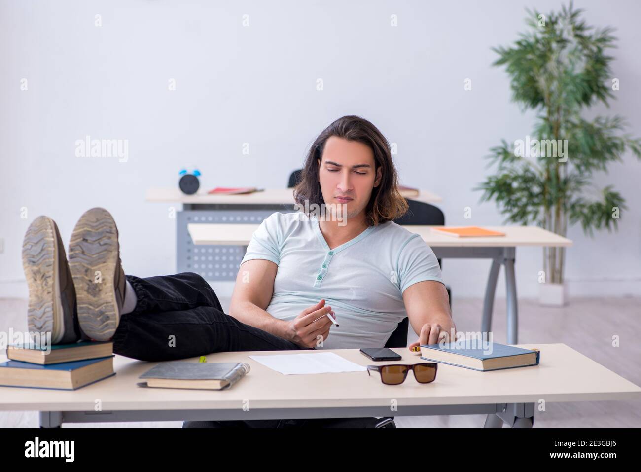 Male student smoking cigarettes in the classroom Stock Photo - Alamy