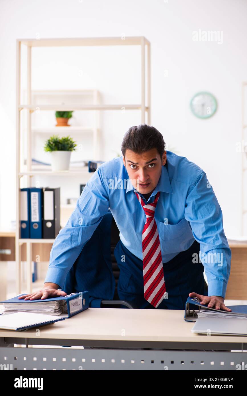 Young businessman doing sport exercises at workplace Stock Photo - Alamy