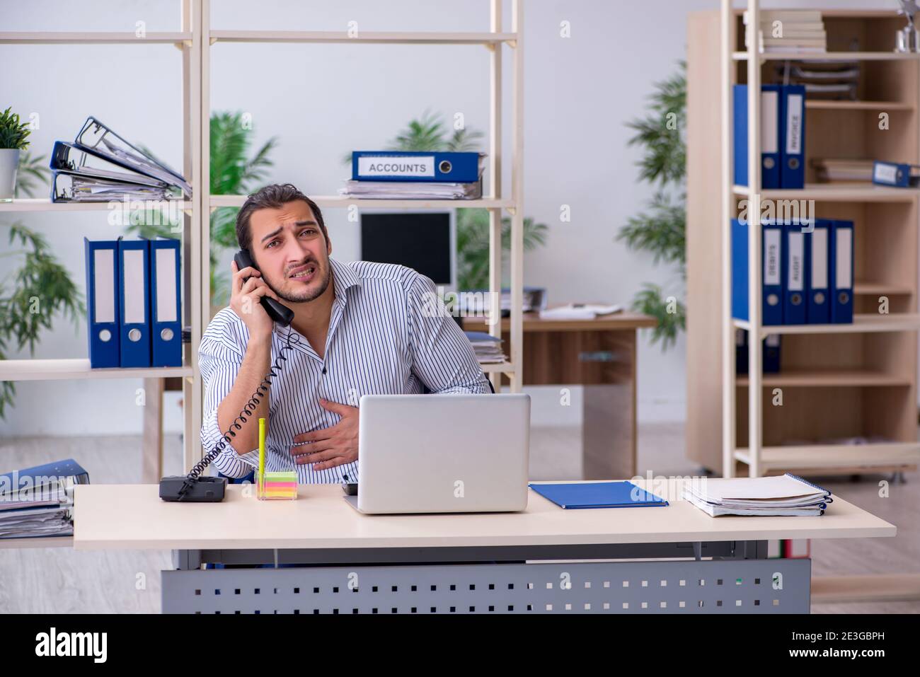 Hungry employee ordering food at workplace Stock Photo - Alamy