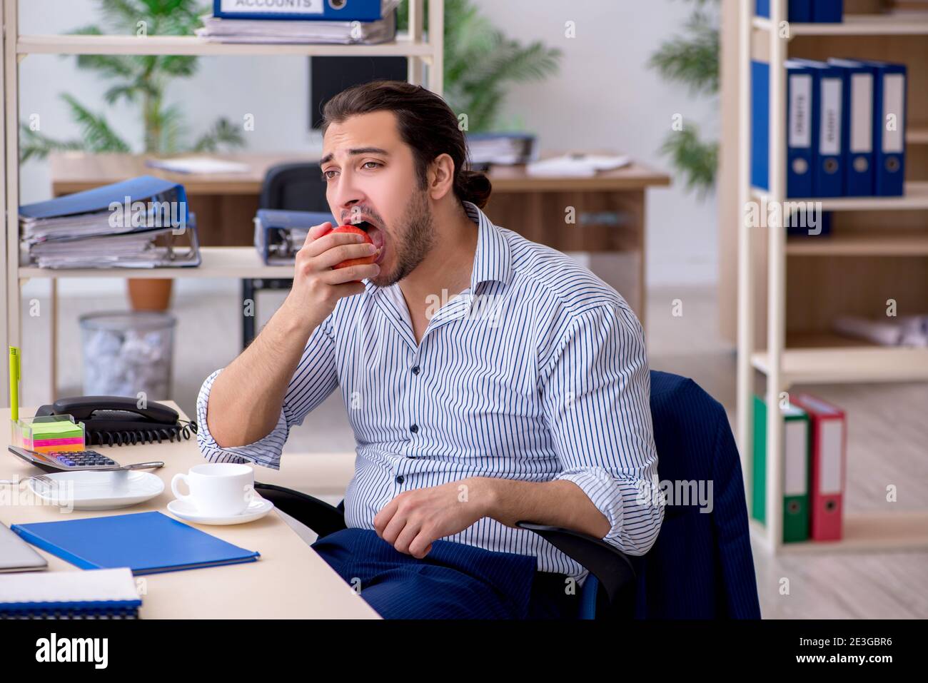 Hungry employee waiting for food at workplace Stock Photo - Alamy