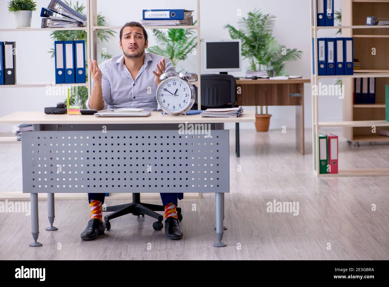 Hungry employee waiting for food in time management concept Stock Photo ...