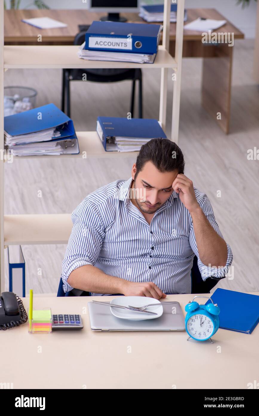 Hungry employee waiting for food in time management concept Stock Photo ...