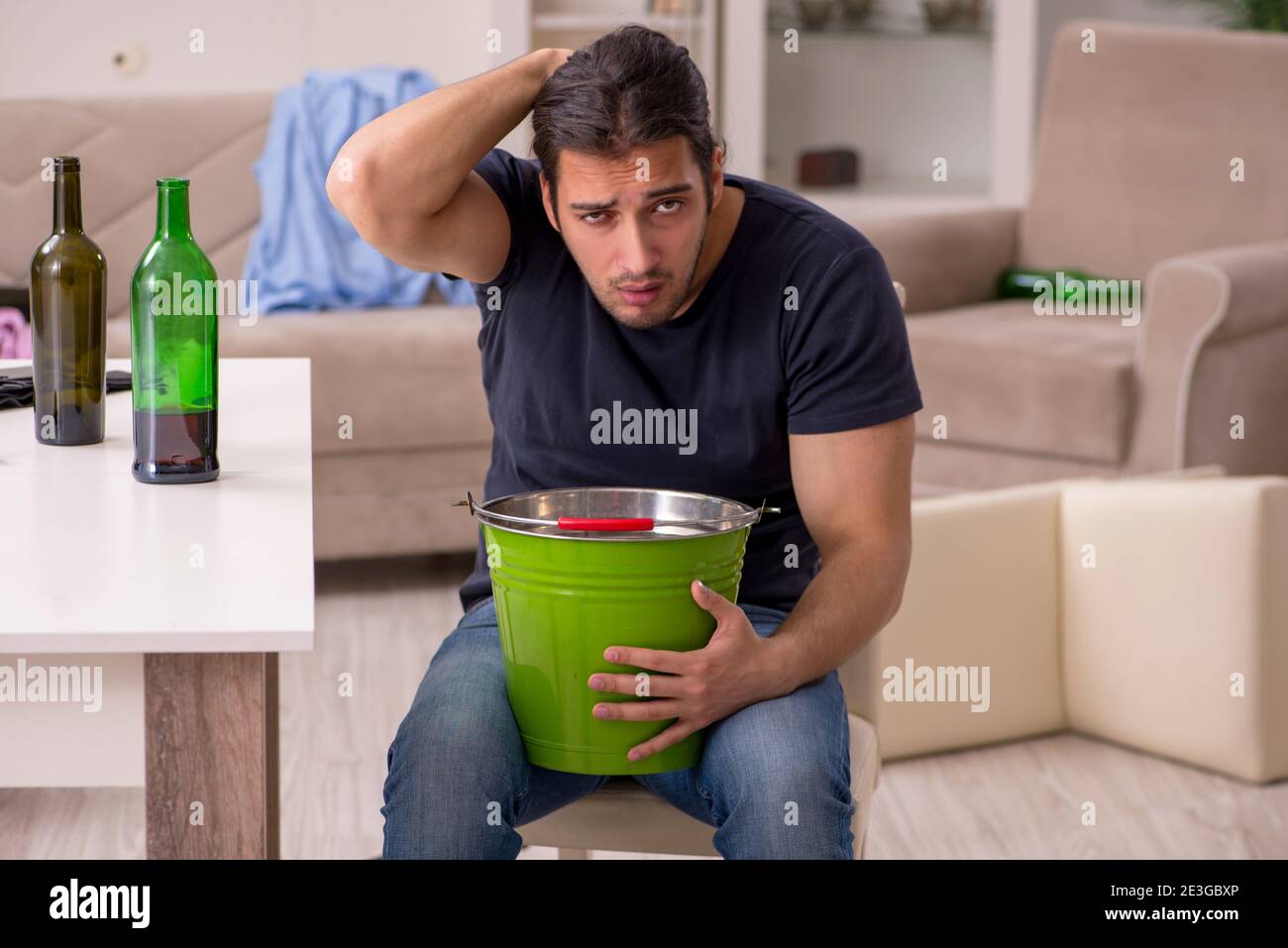 Young addicted man suffering from stomachache at home Stock Photo - Alamy