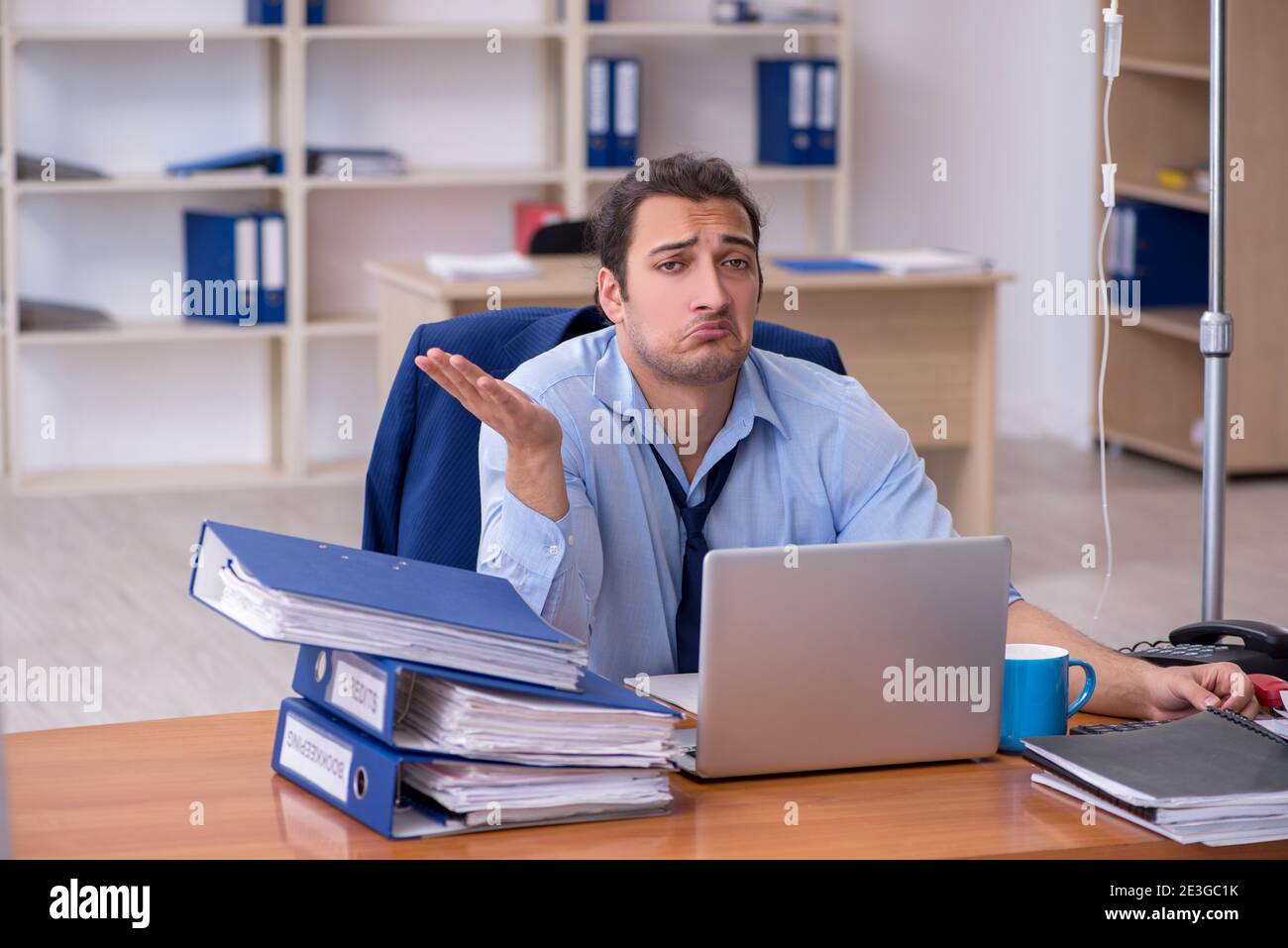 Male employee suffering at workplace Stock Photo - Alamy
