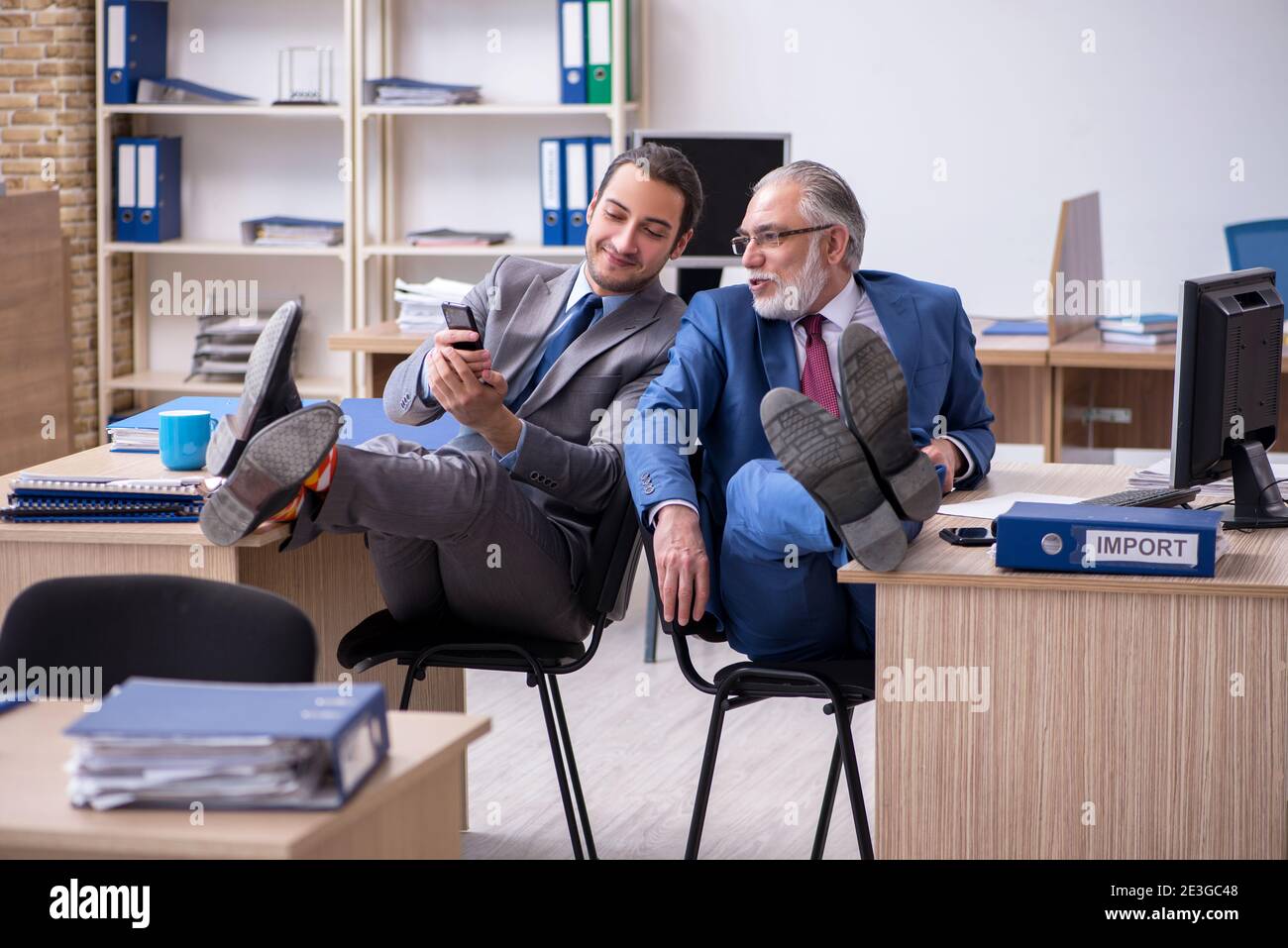 Two employees working in the office Stock Photo - Alamy