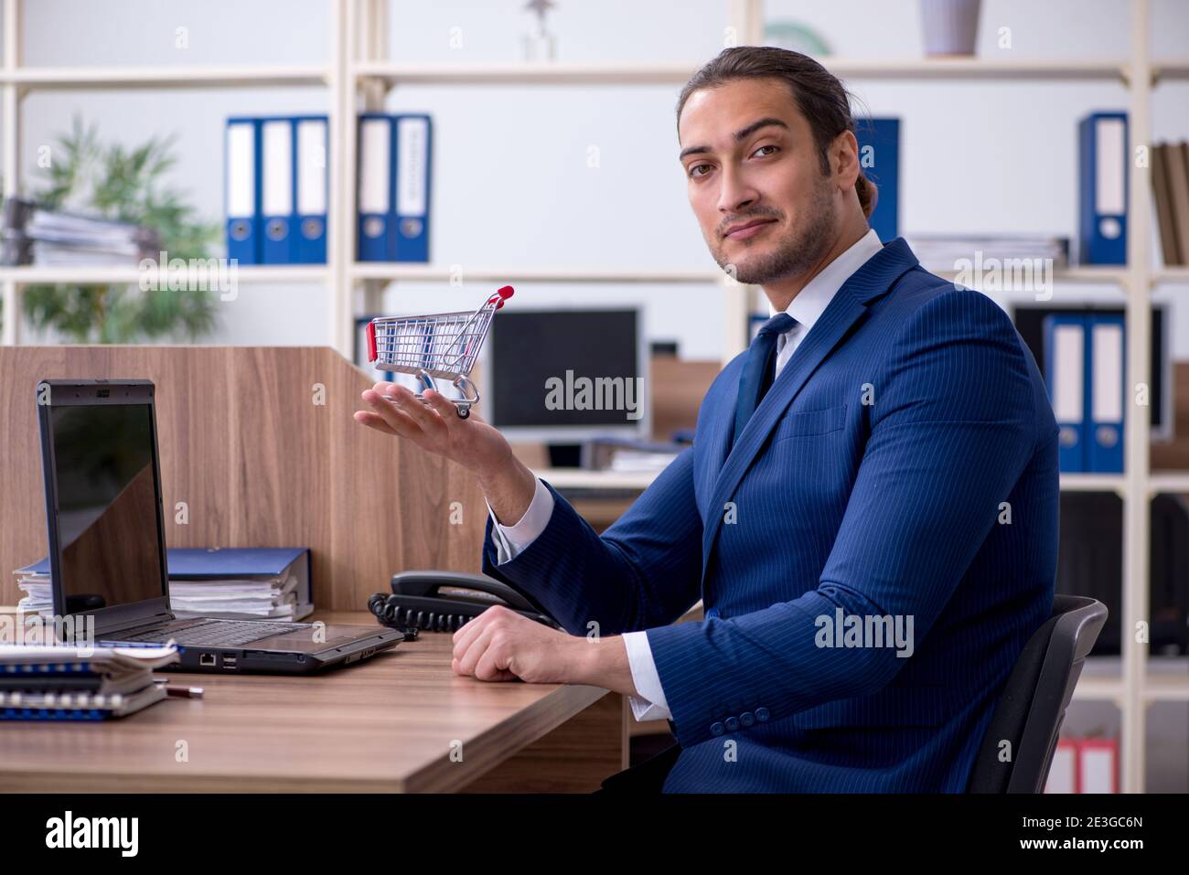 Young employee in e-commerce concept Stock Photo - Alamy