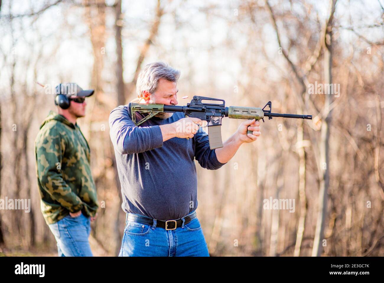 Family shooting guns practice and hanging out Stock Photo - Alamy
