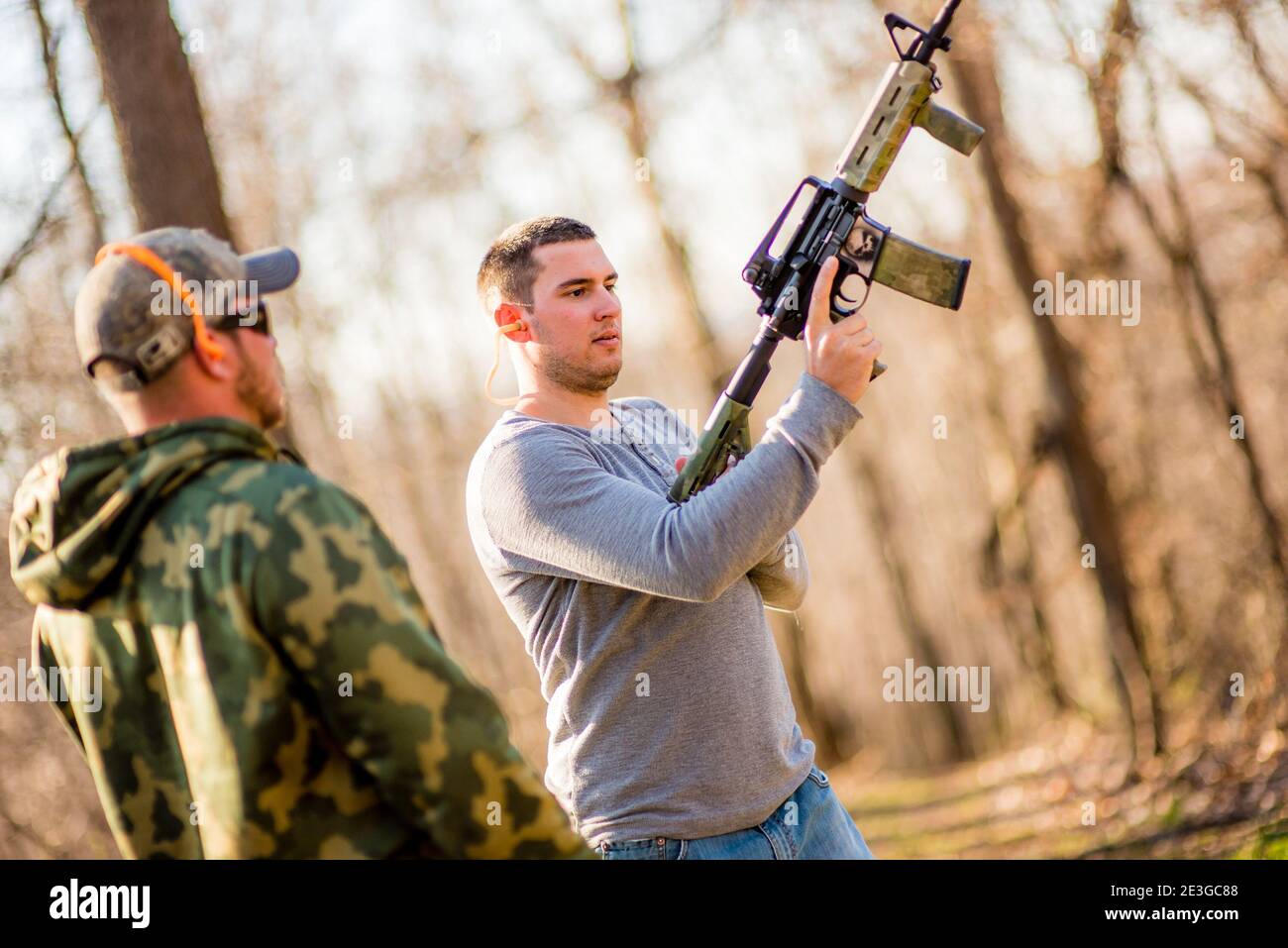 Family shooting guns practice and hanging out Stock Photo - Alamy