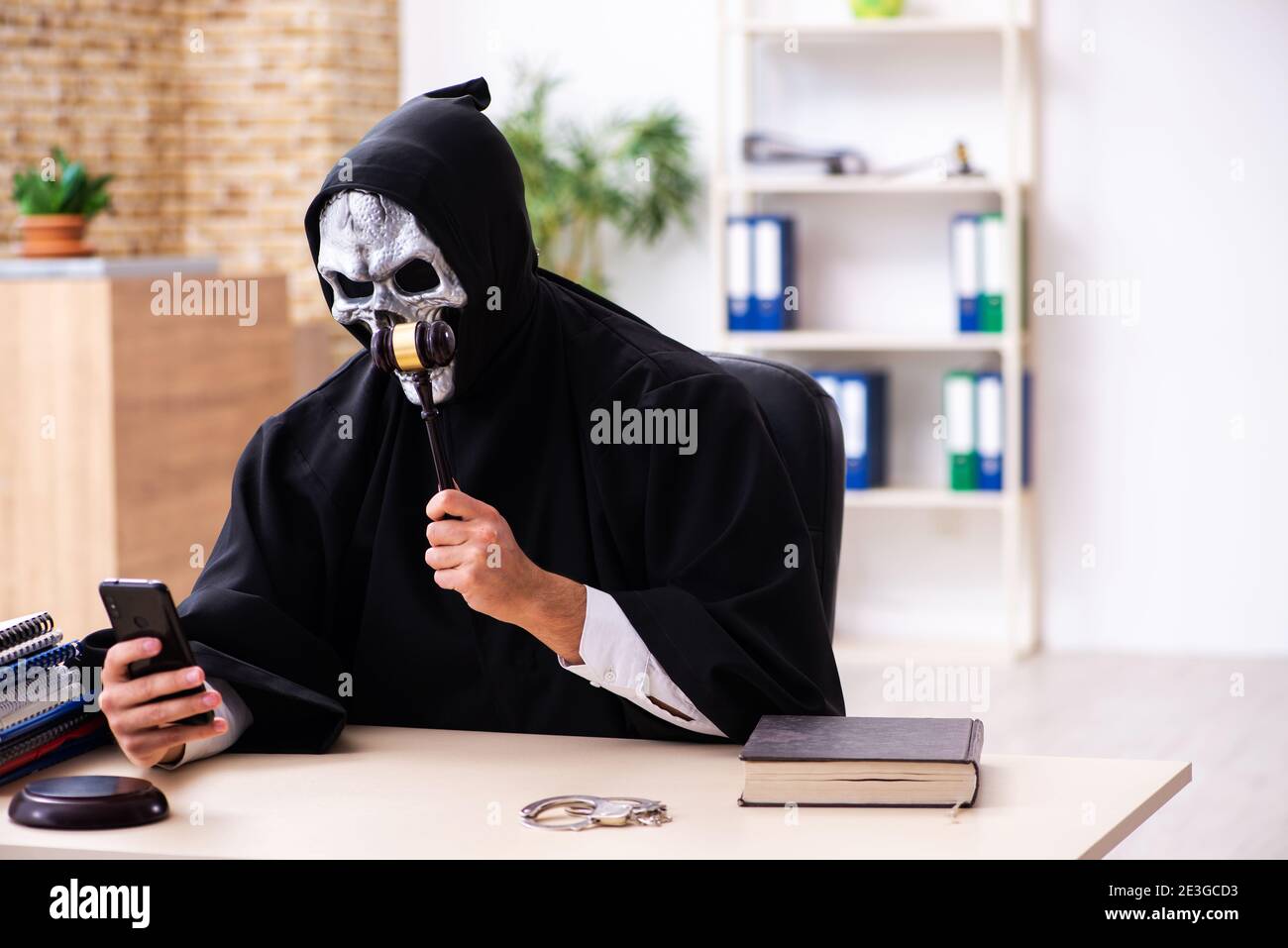 Devil judge working in the courthouse Stock Photo - Alamy