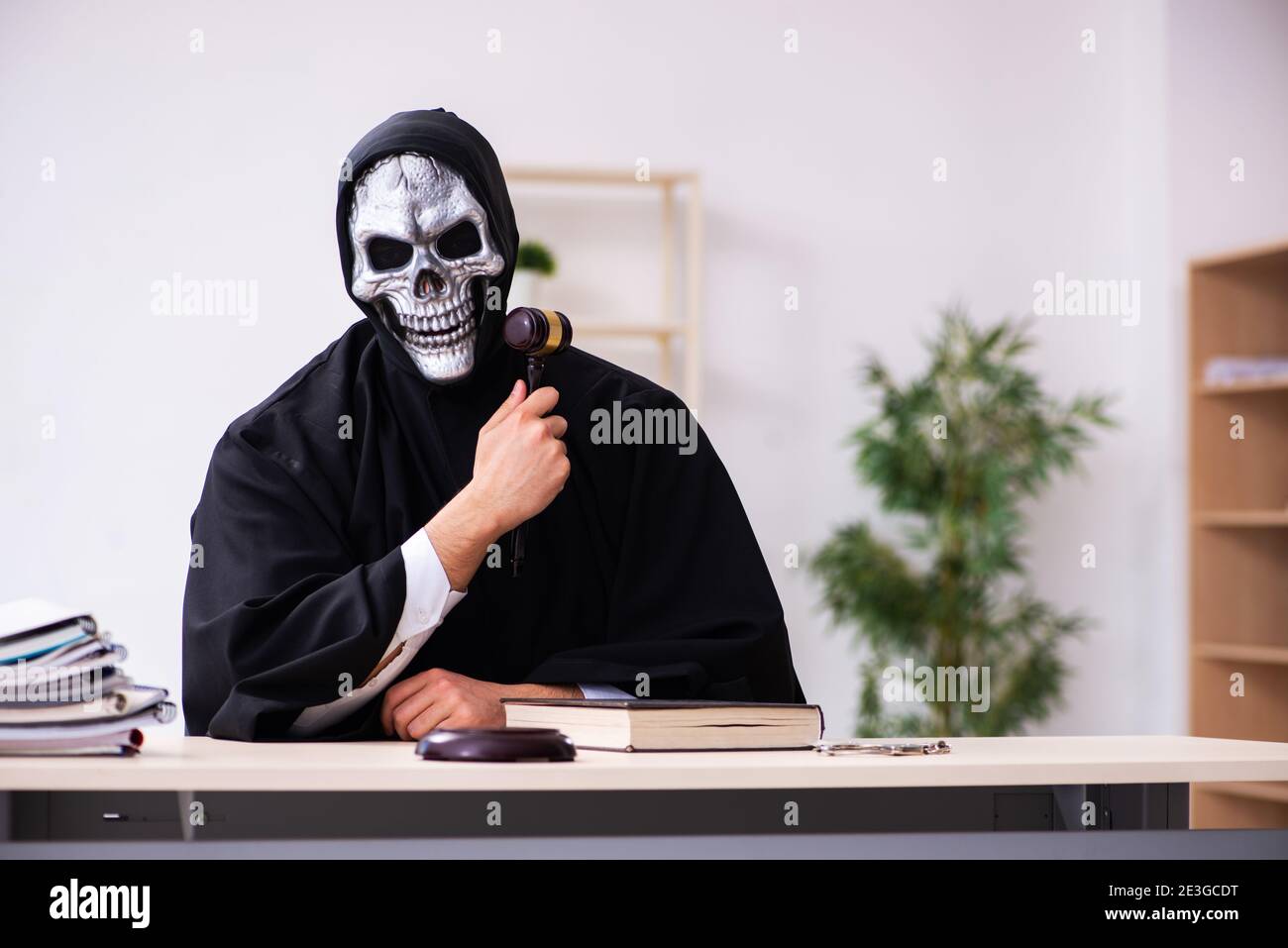 Devil judge working in the courthouse Stock Photo - Alamy
