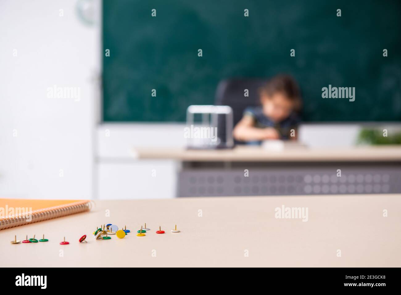 Little girl and thumbtacks in the classroom Stock Photo - Alamy
