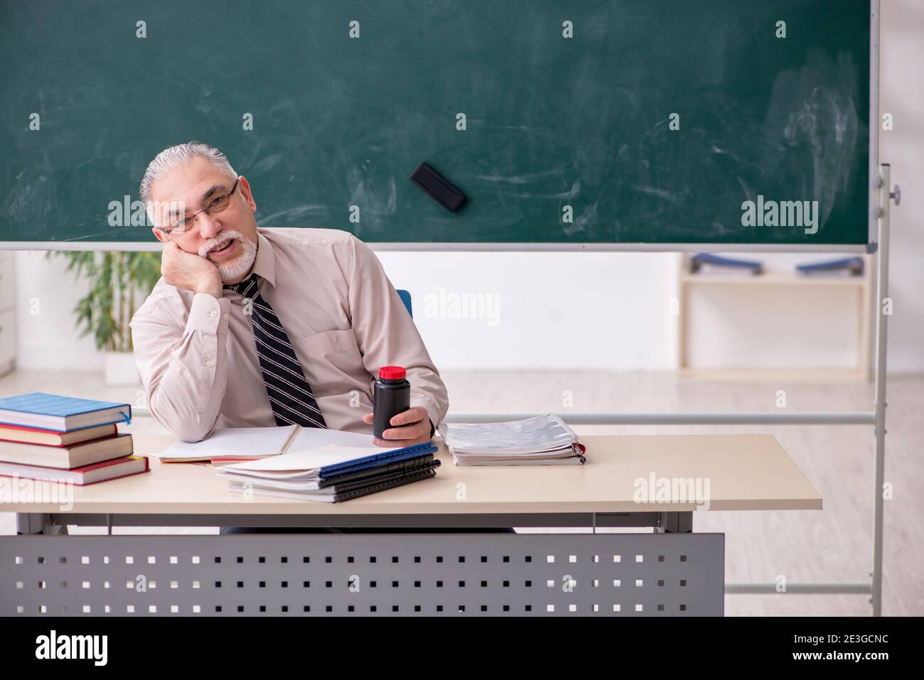 Old experienced teacher in the classroom Stock Photo - Alamy