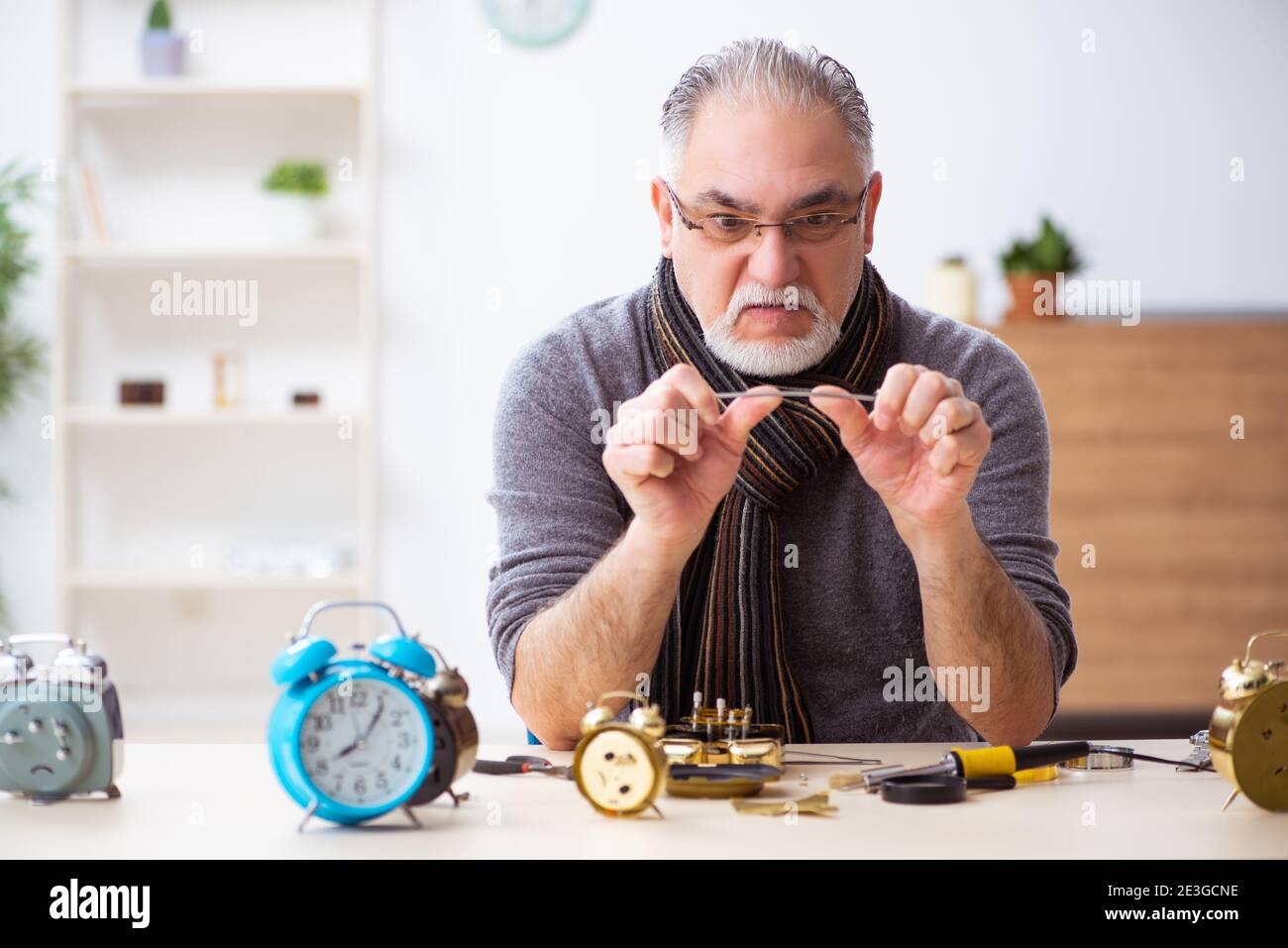 Old watchmaker working in the workshop Stock Photo - Alamy