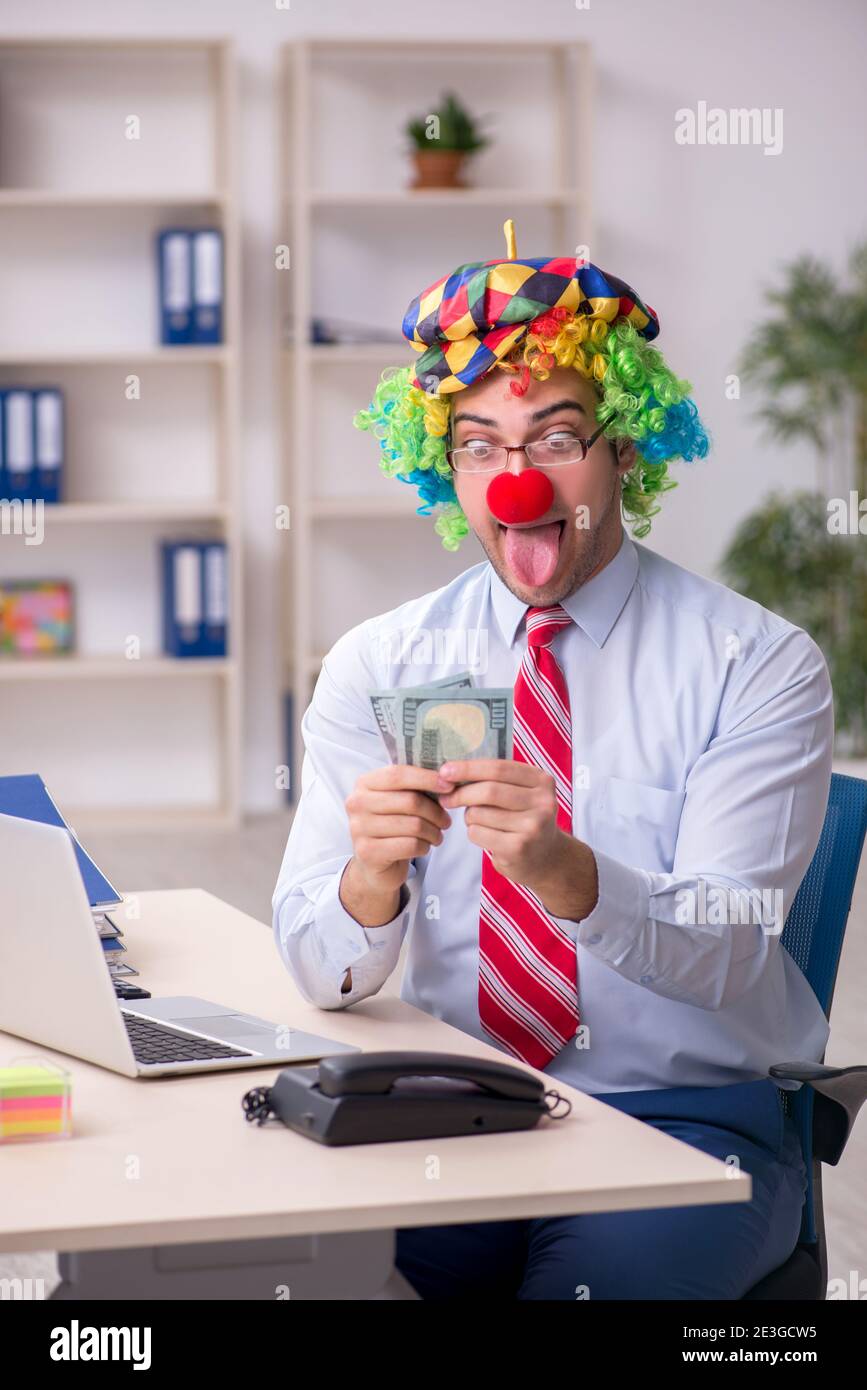 Funny employee clown working in the office room Stock Photo - Alamy
