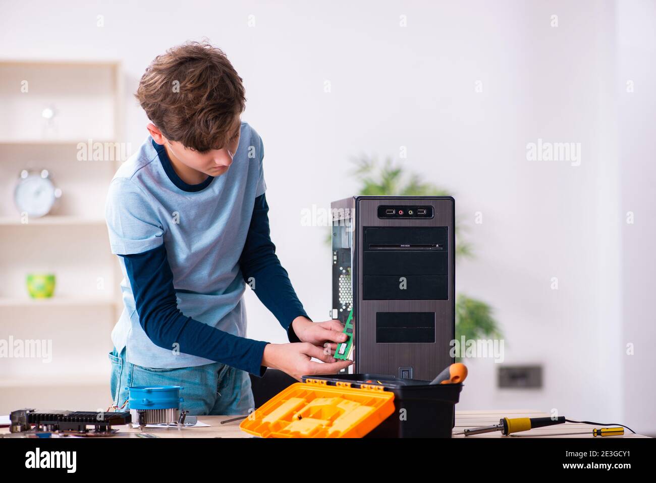 Teenager reparing computers at workshop Stock Photo - Alamy