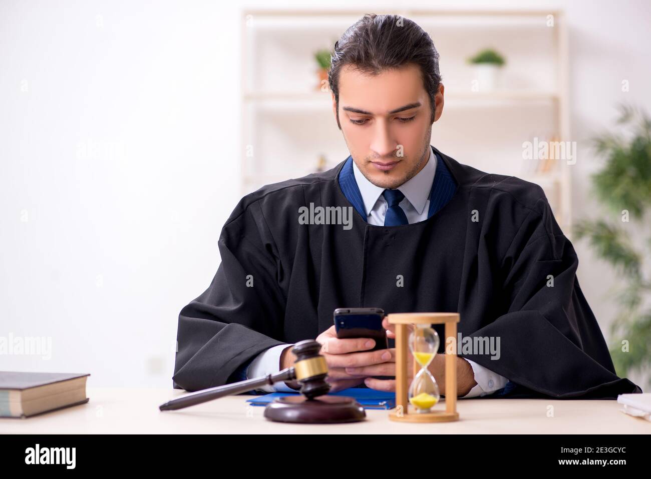 Young judge in time management concept Stock Photo - Alamy