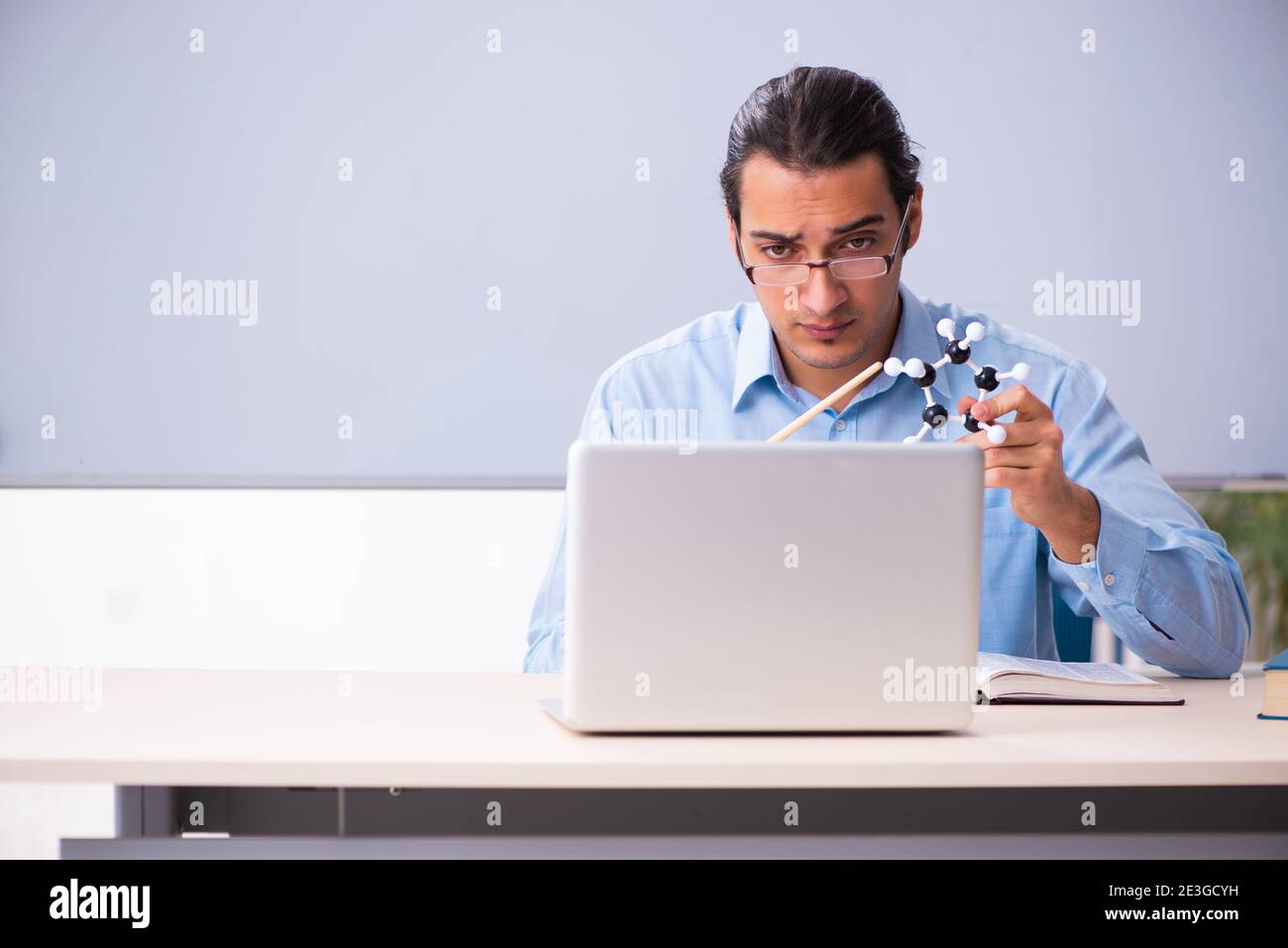 Young physics teacher in front of whiteboard Stock Photo - Alamy