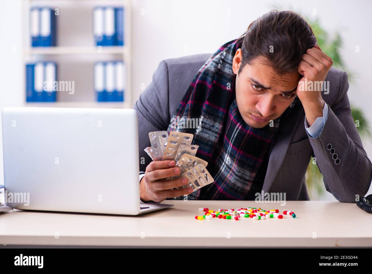 Young employee suffering at workplace Stock Photo - Alamy