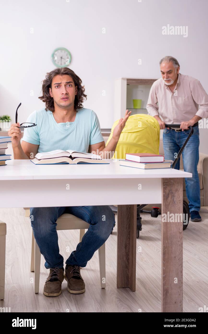 Old grandfather looking after newborn at home Stock Photo - Alamy