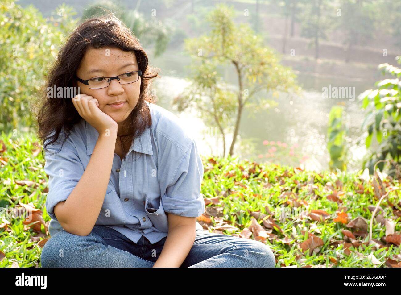 portrait of asian female teenager contemplating in nature environment ...