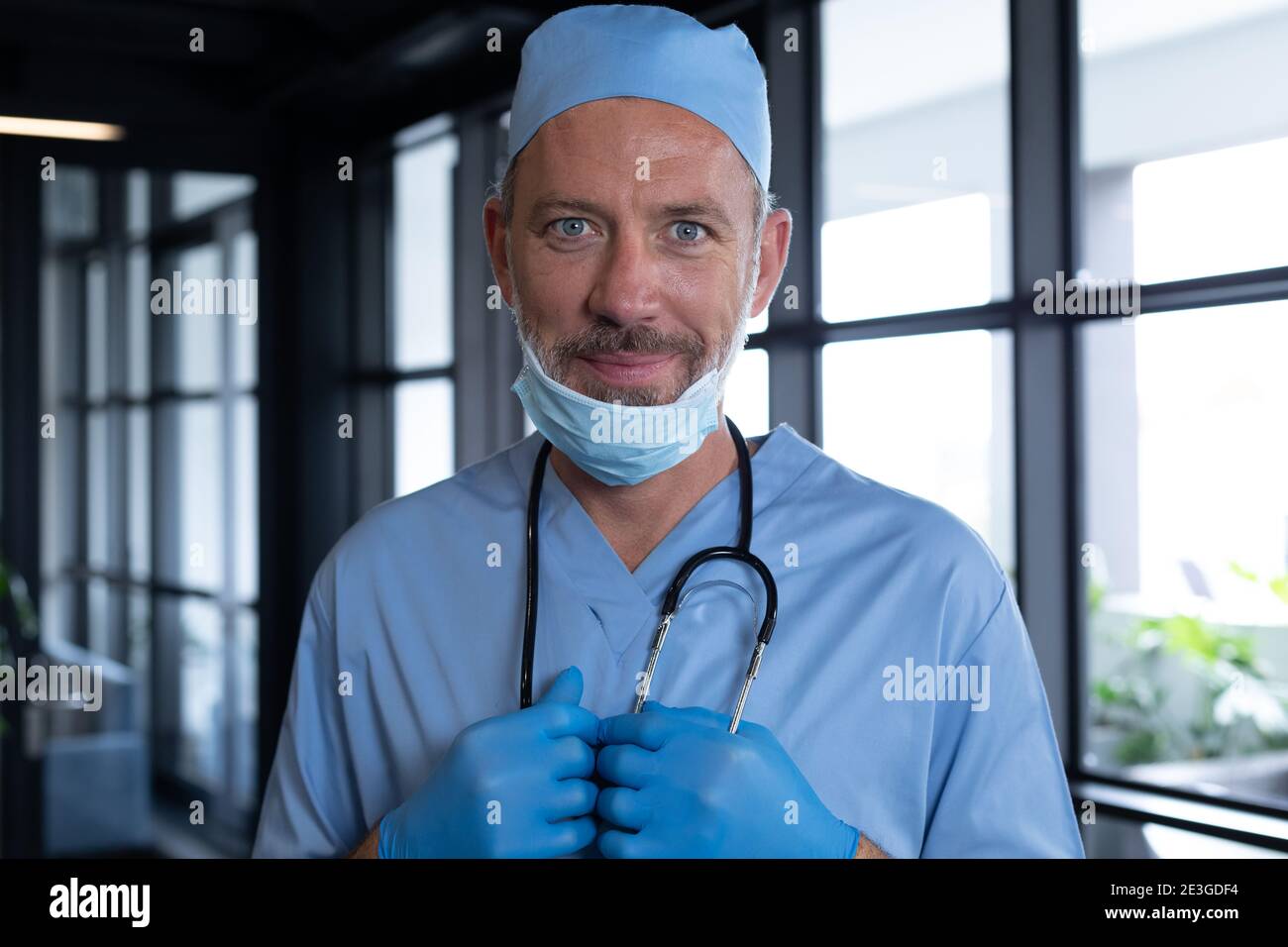 Portrait of caucasian male doctor standing looking at the camera and ...