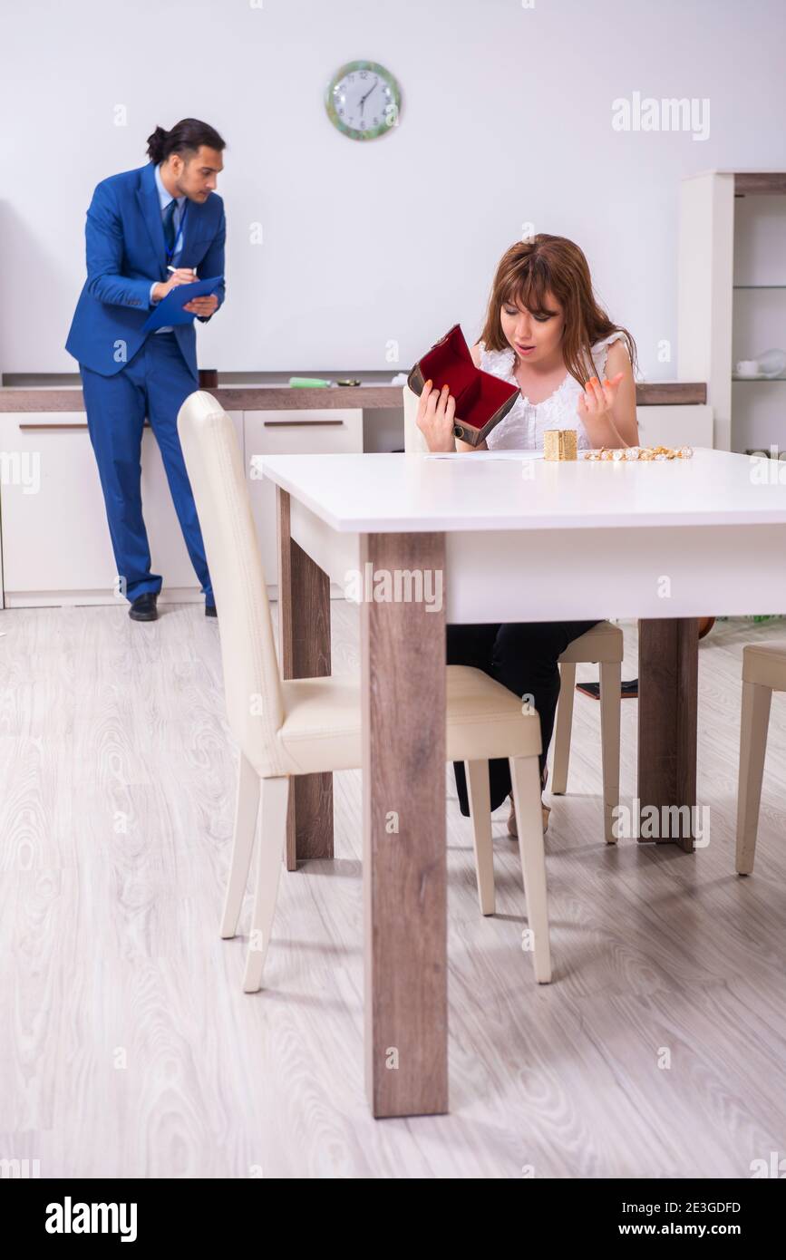 Female owner and police officer in housebreaking concept Stock Photo ...