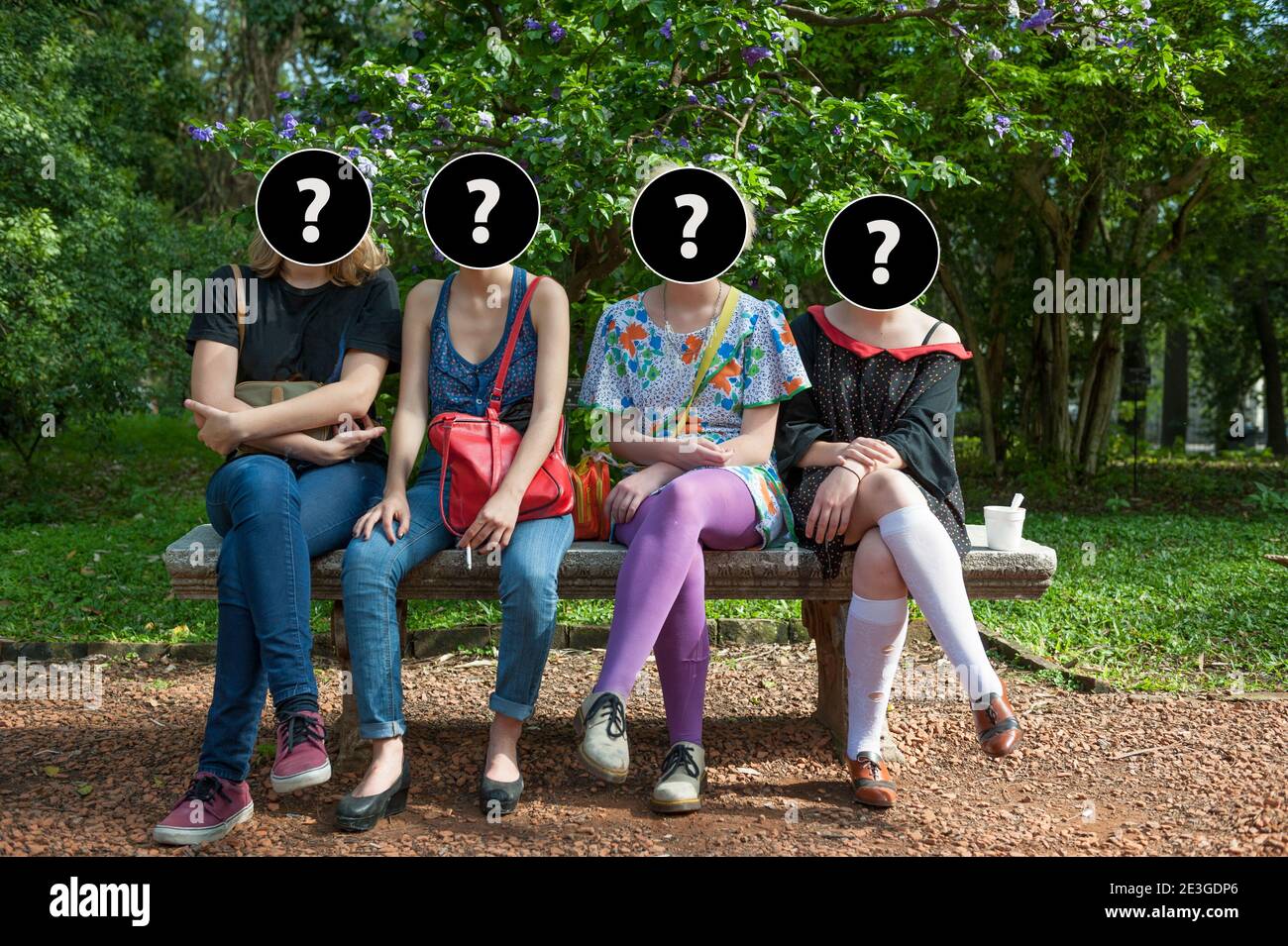 Four young women or girls hiding their identity in a greeen park Stock ...
