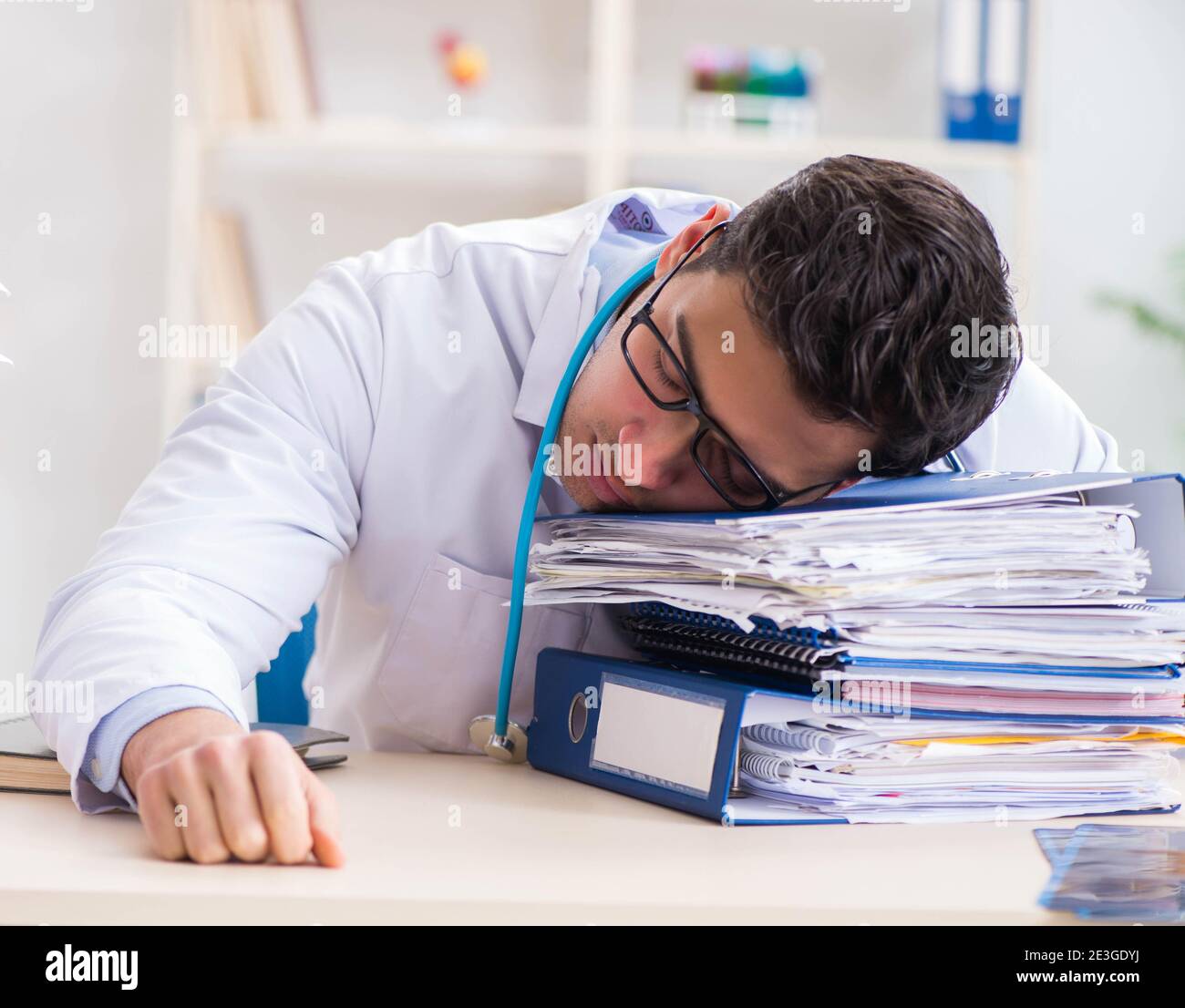 The busy doctor with too much work in hospital Stock Photo - Alamy