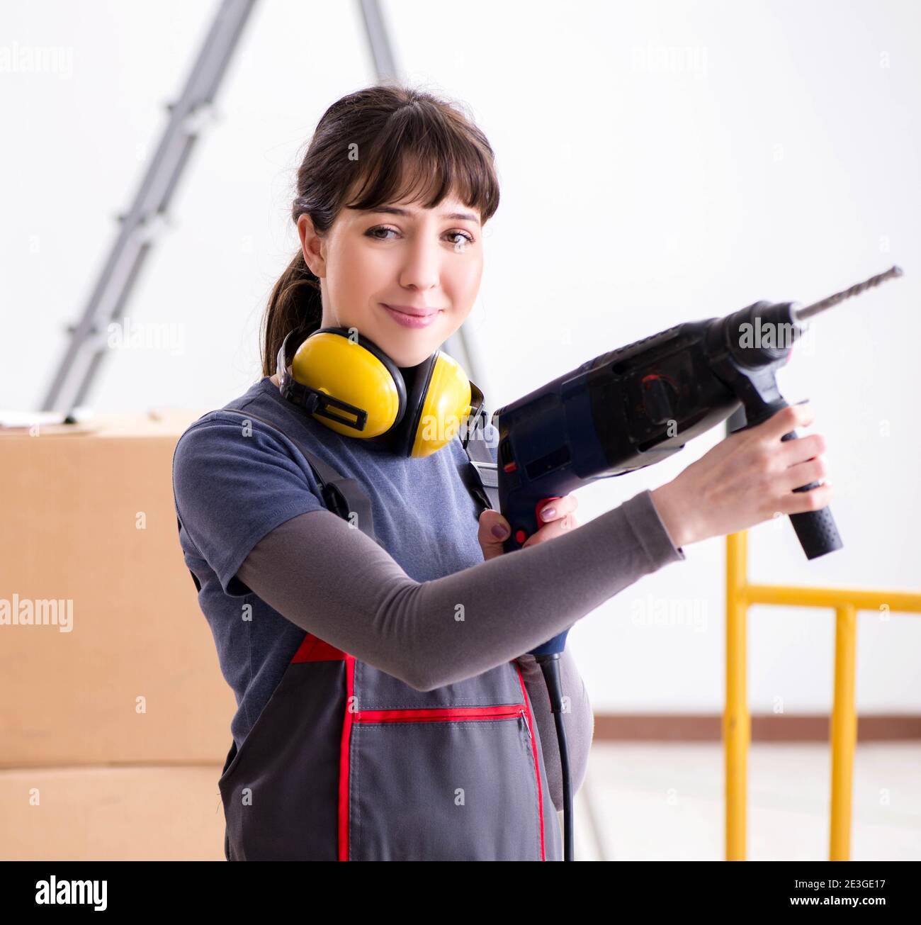 The woman contractor with hand drill at construction site Stock Photo ...