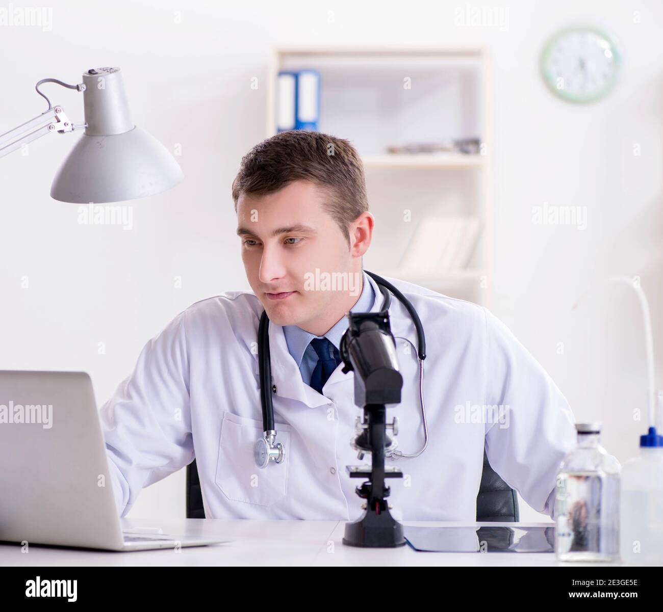 The male doctor looking at lab results in hospital Stock Photo - Alamy
