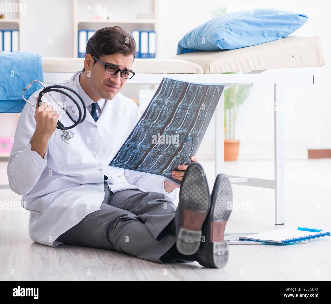 The doctor sitting on the floor in hospital Stock Photo - Alamy