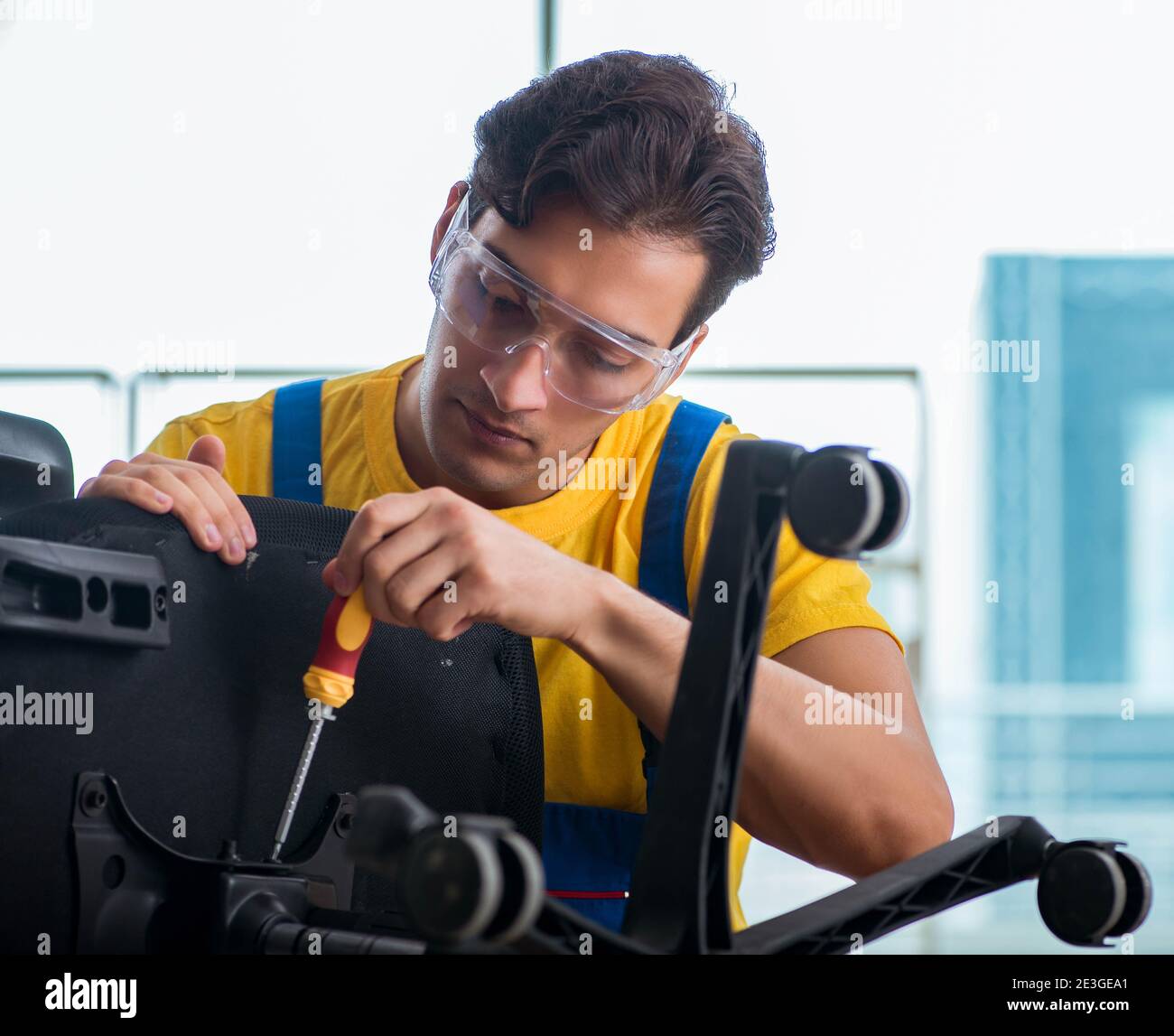 The furniture repairman working on repairing the chair Stock Photo - Alamy