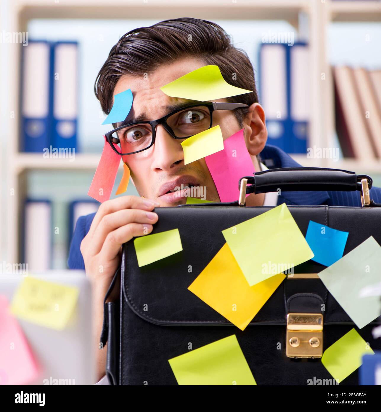 The businessman with reminder notes in multitasking concept Stock Photo ...