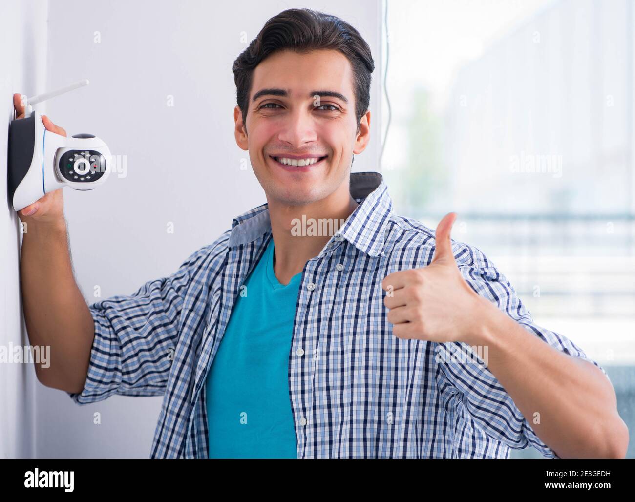 The man installing surveillance cctv cameras at home Stock Photo - Alamy