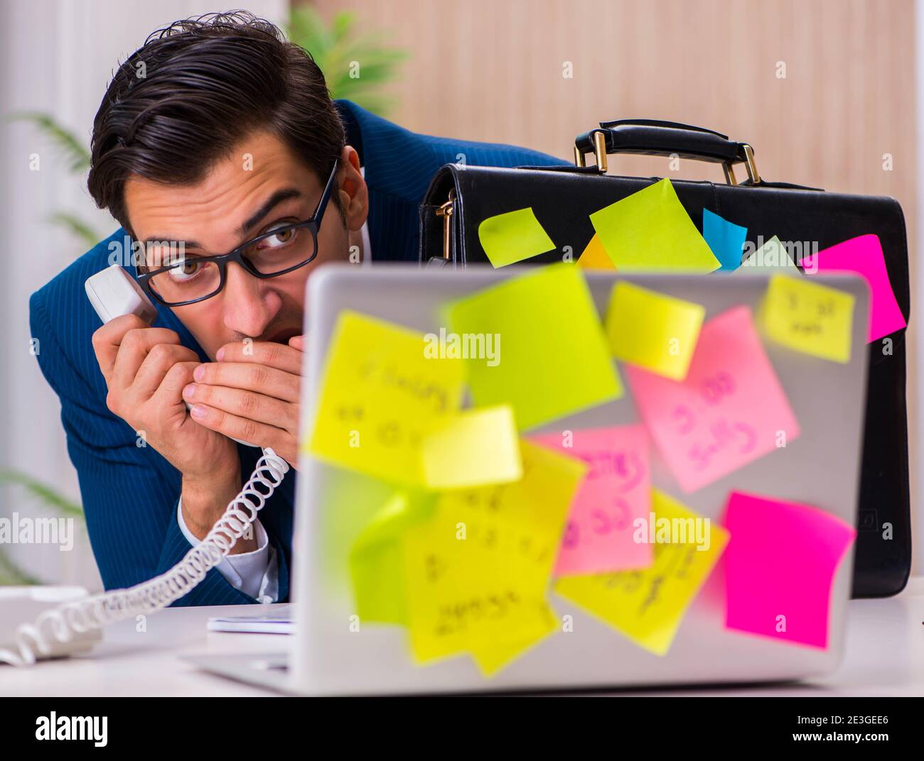 The businessman with reminder notes in multitasking concept Stock Photo ...