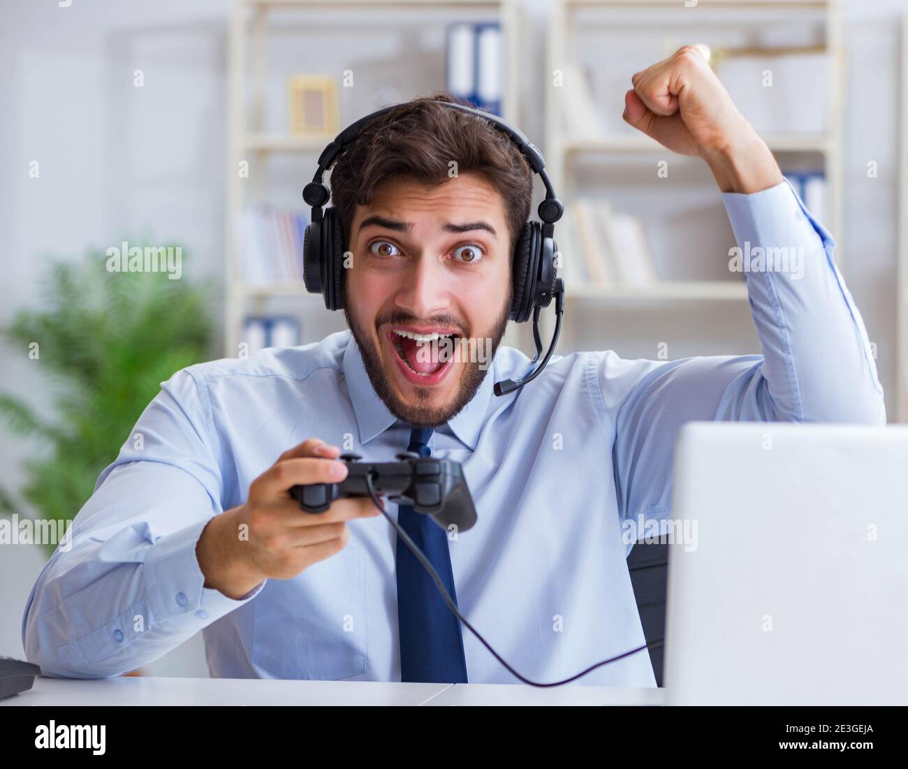 The businessman gamer in office playing games Stock Photo - Alamy