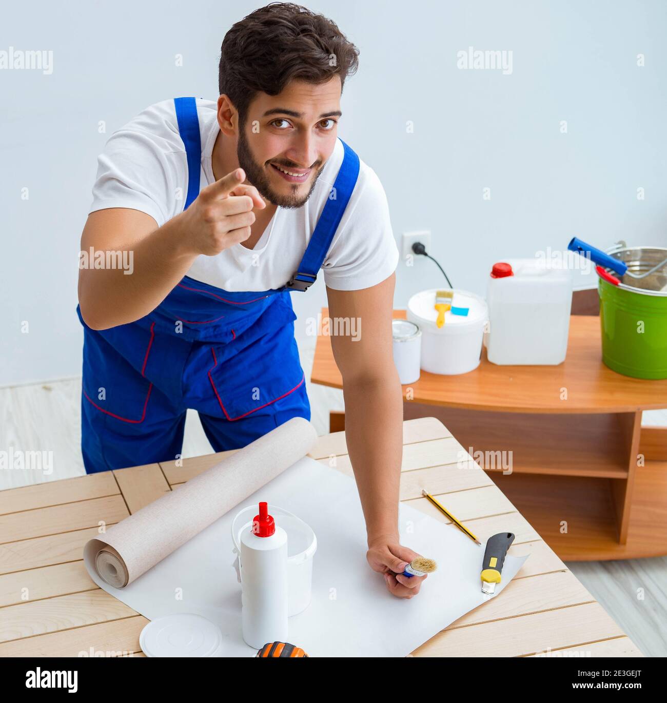 The worker working on wallpaper during refurbishment Stock Photo - Alamy