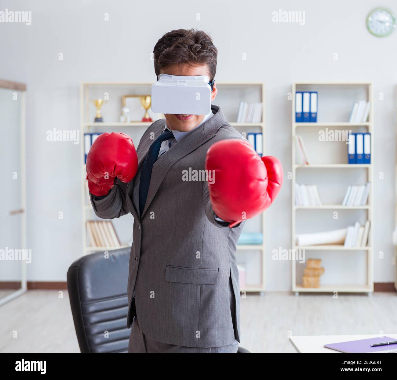 The man boxing in the office with virtual reality goggles Stock Photo ...