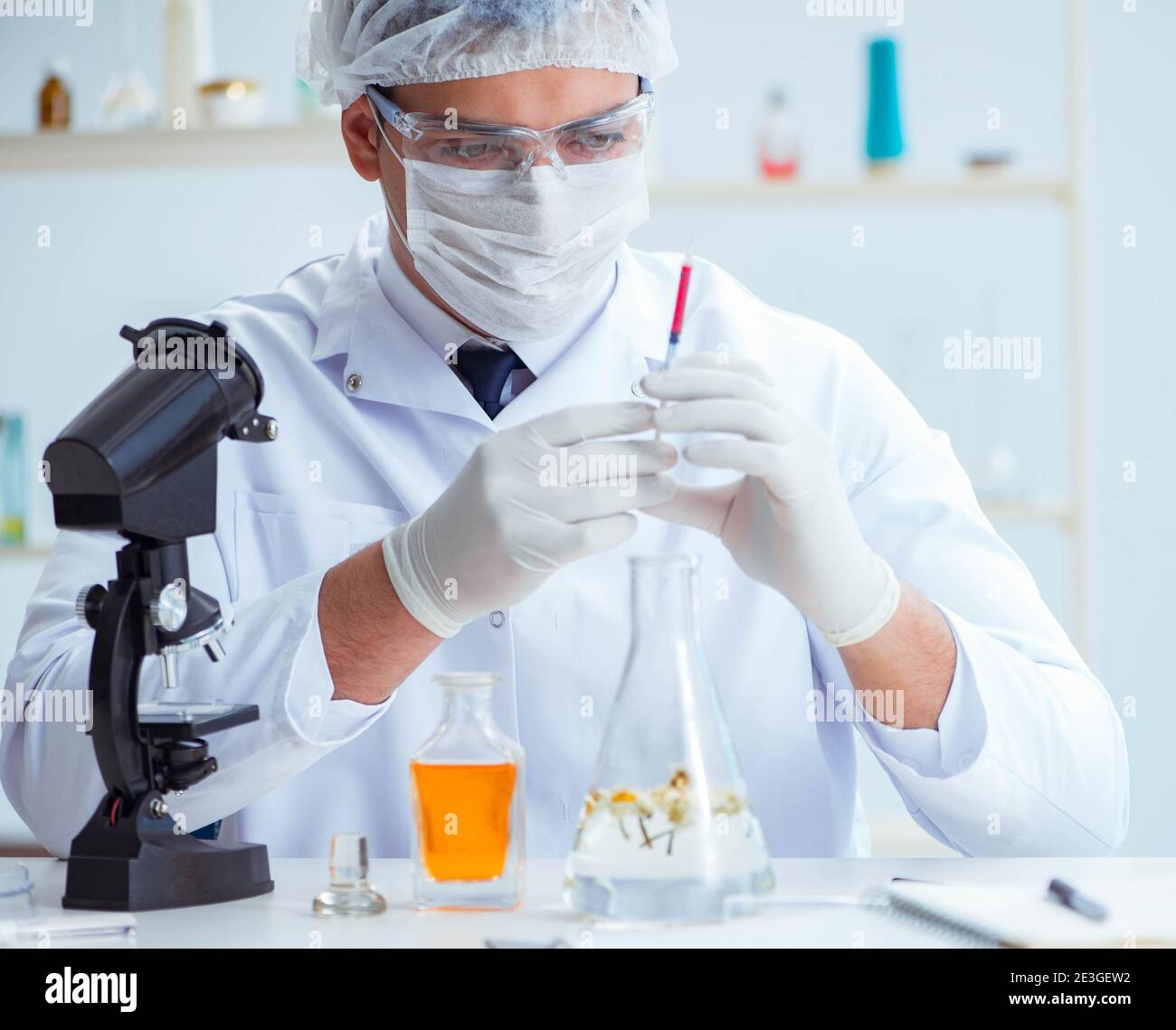 The chemist mixing perfumes in the lab Stock Photo - Alamy