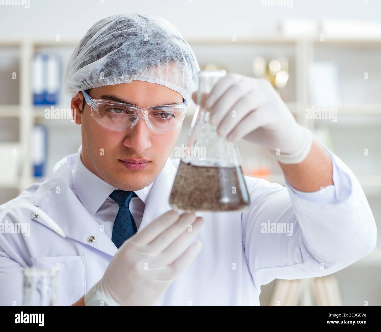 Young researcher scientist doing a water test contamination experiment ...