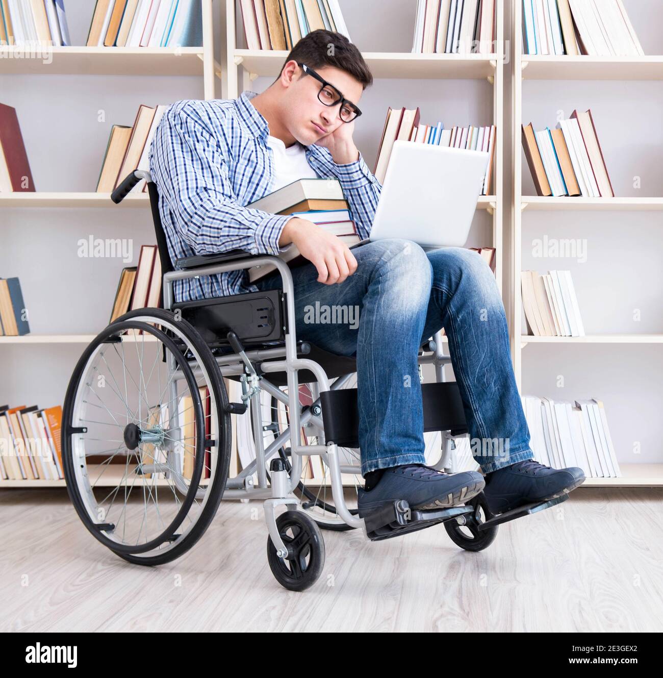 The disabled student studying in the library Stock Photo - Alamy