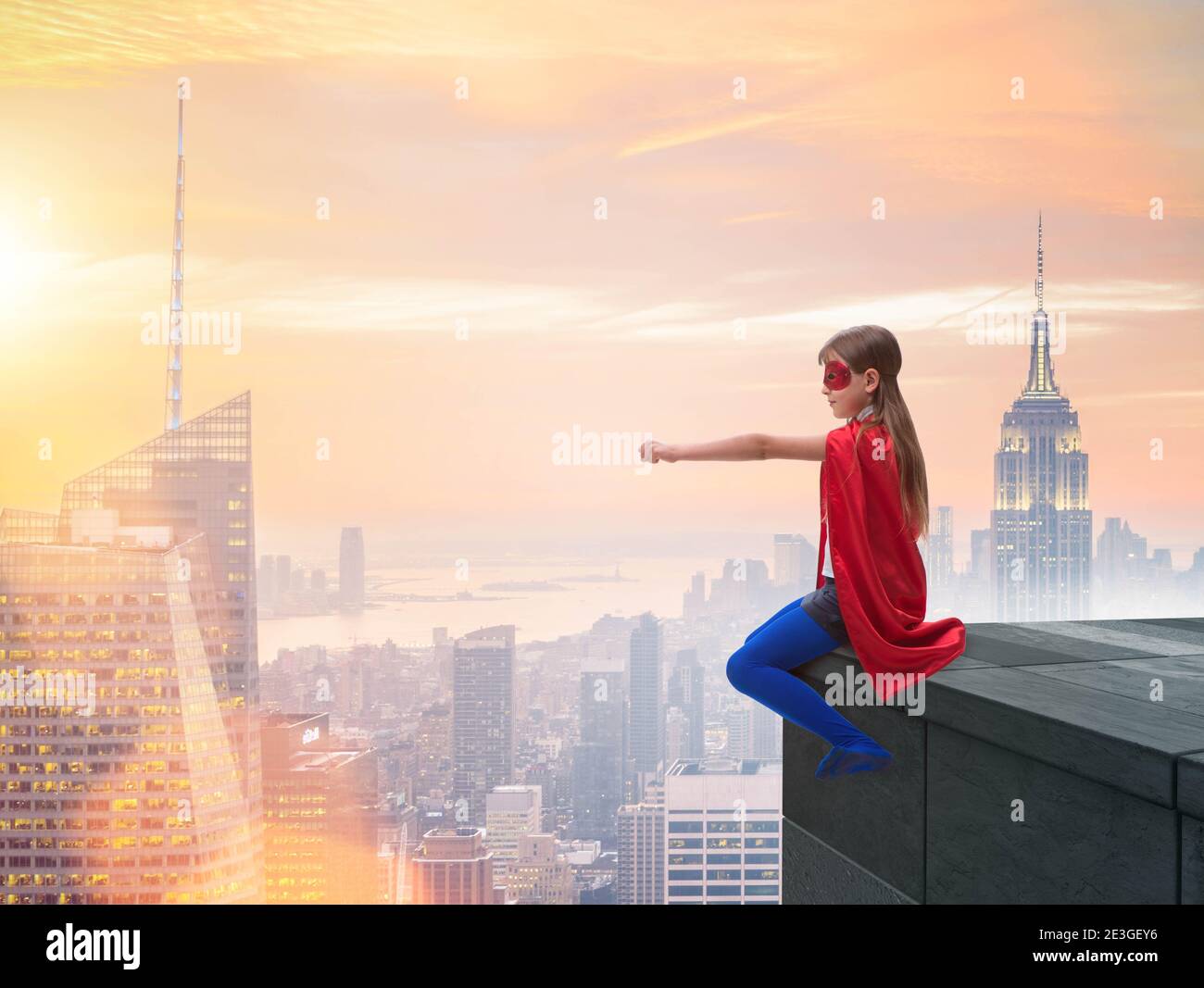 The young girl in superhero costume overlooking the city Stock Photo ...