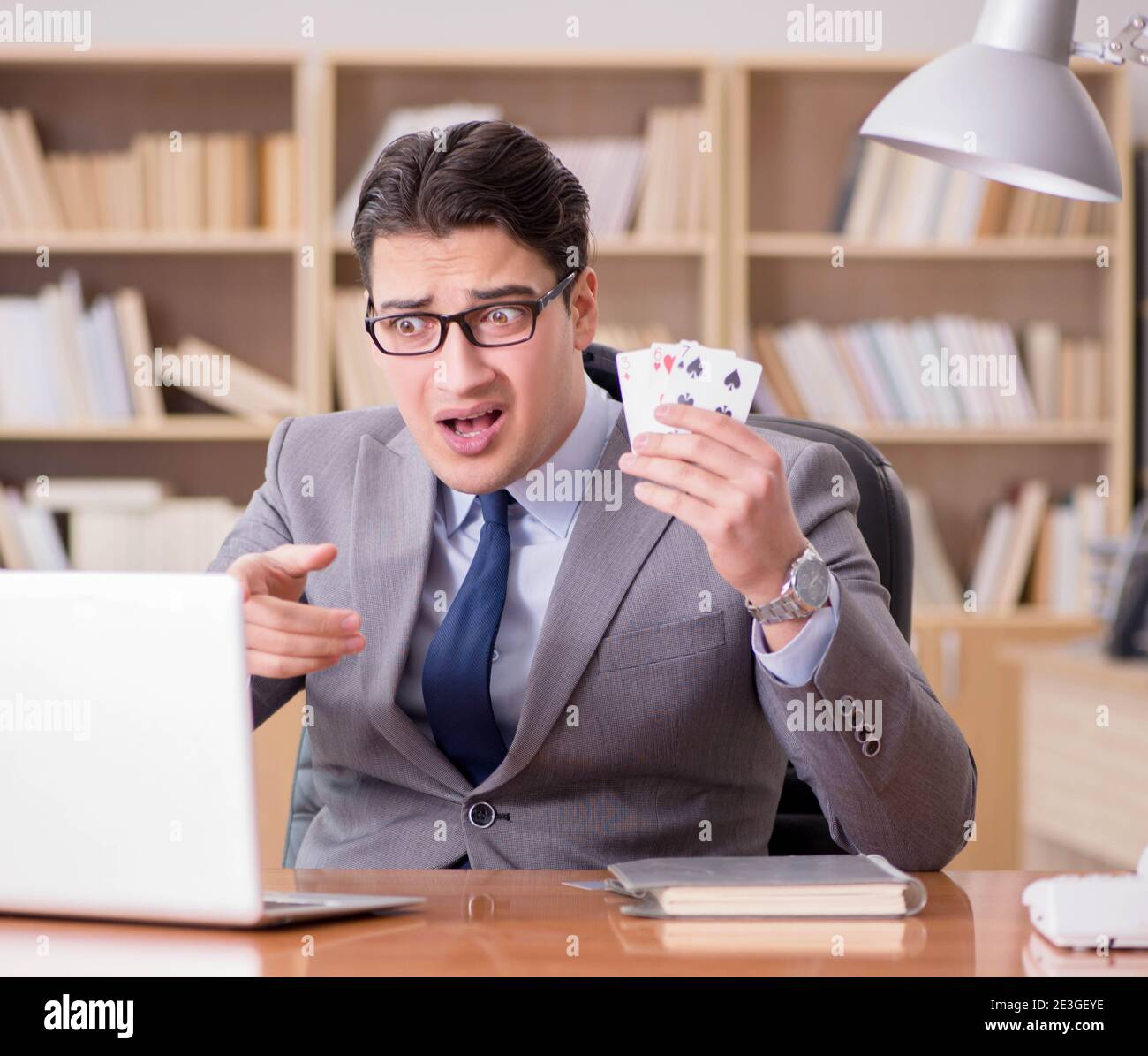 The businessman gambling playing cards at work Stock Photo - Alamy