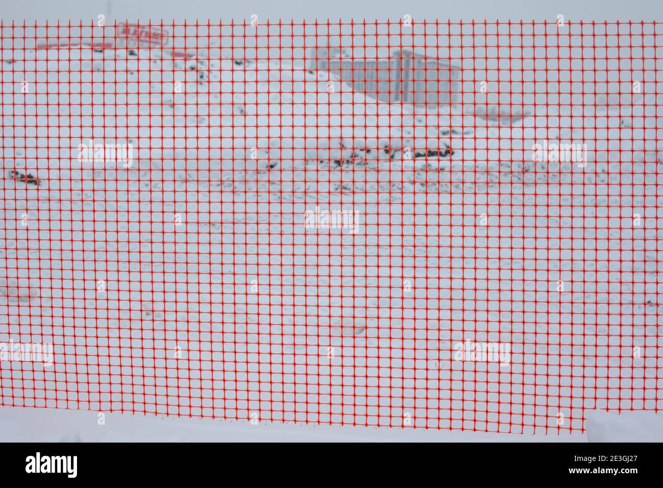 Plastic red safety net for construction site. Fencing repair work on ...