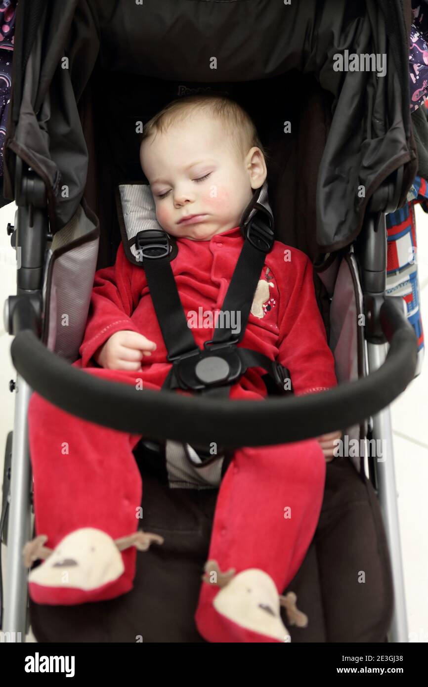 Toddler is sleeping in a stroller indoor Stock Photo - Alamy