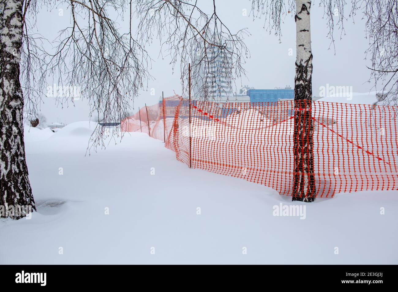 Plastic red safety net for construction site. Fencing repair work on ...