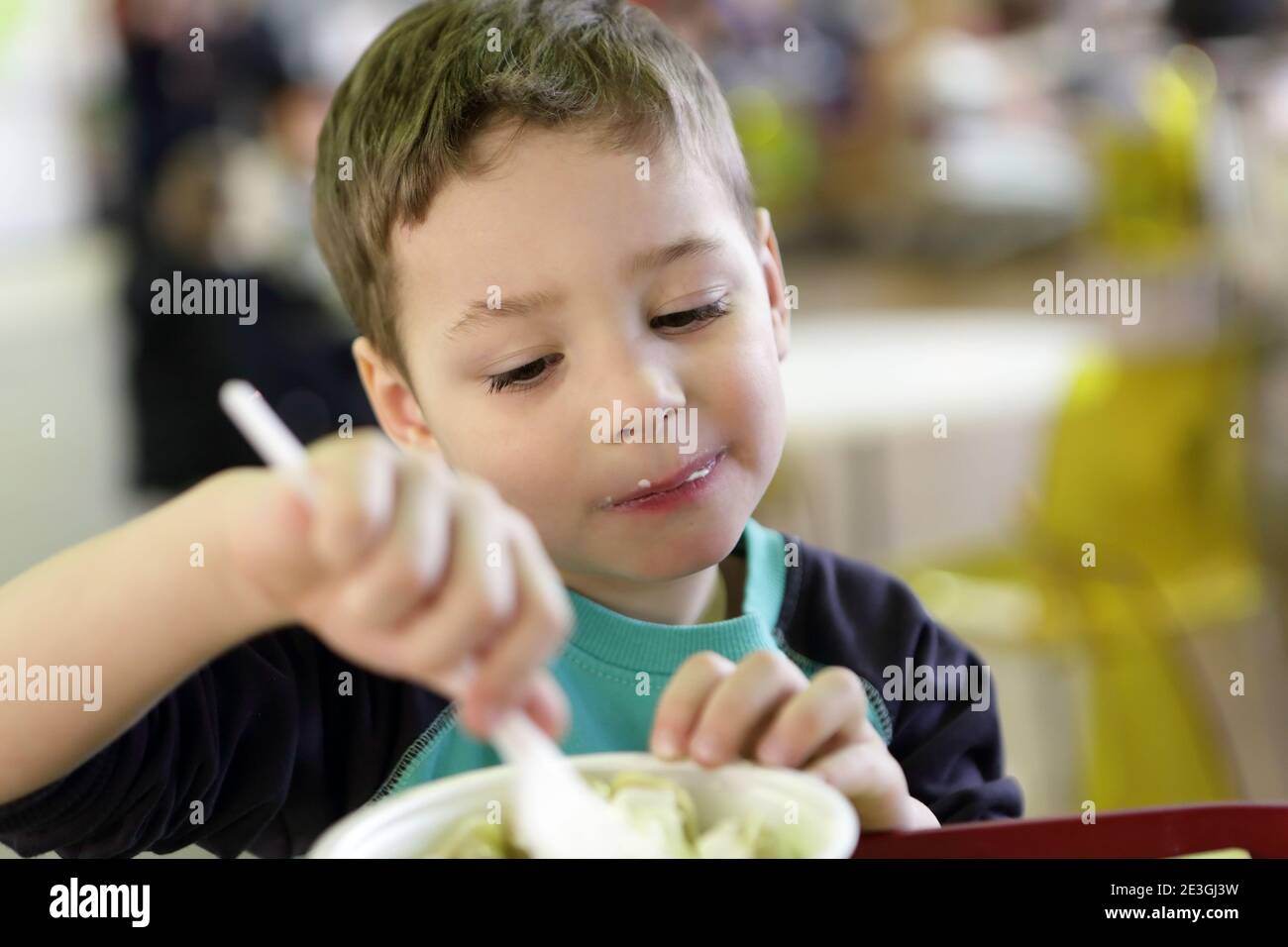 Kid eating pelmeni in the fast food area Stock Photo - Alamy