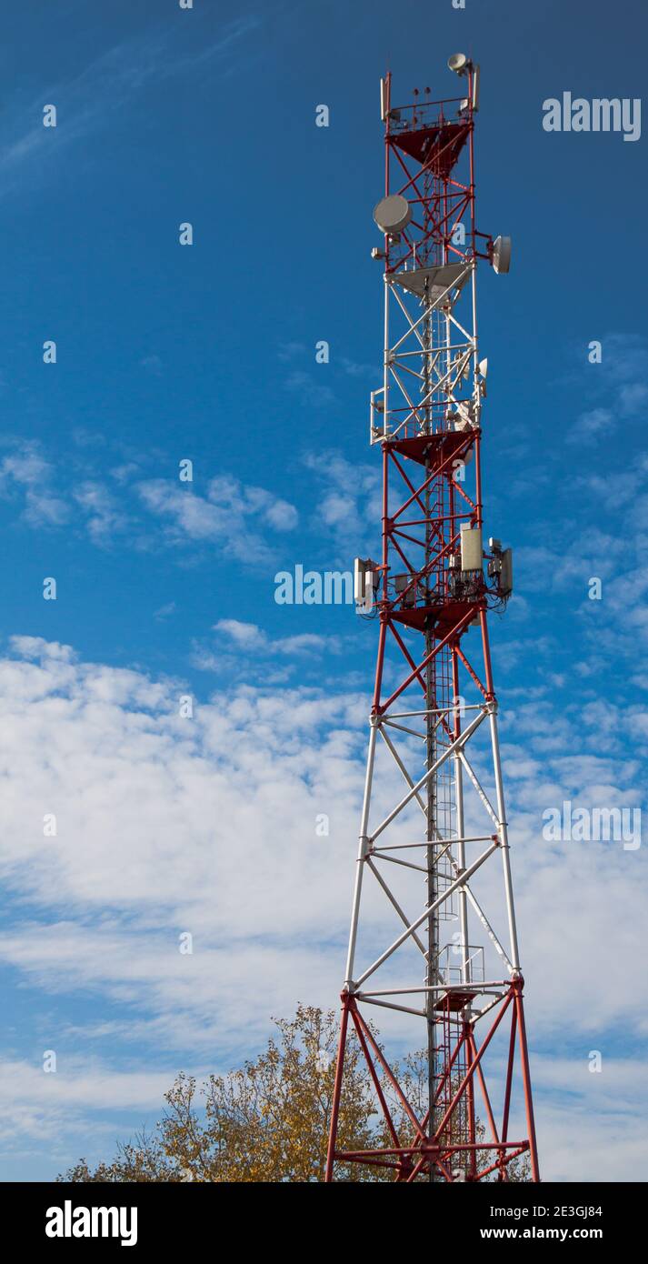 4G 5G cellular repeaters against a blue sky. Mobile phone Telecommunication Radio antenna Tower ...