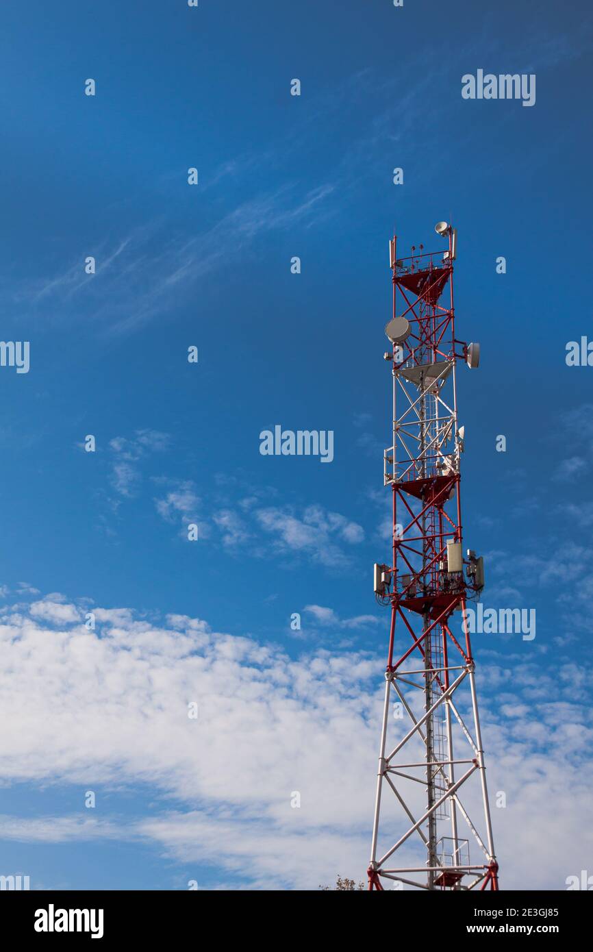 4G 5G cellular repeaters against a blue sky. Mobile phone Telecommunication Radio antenna Tower ...